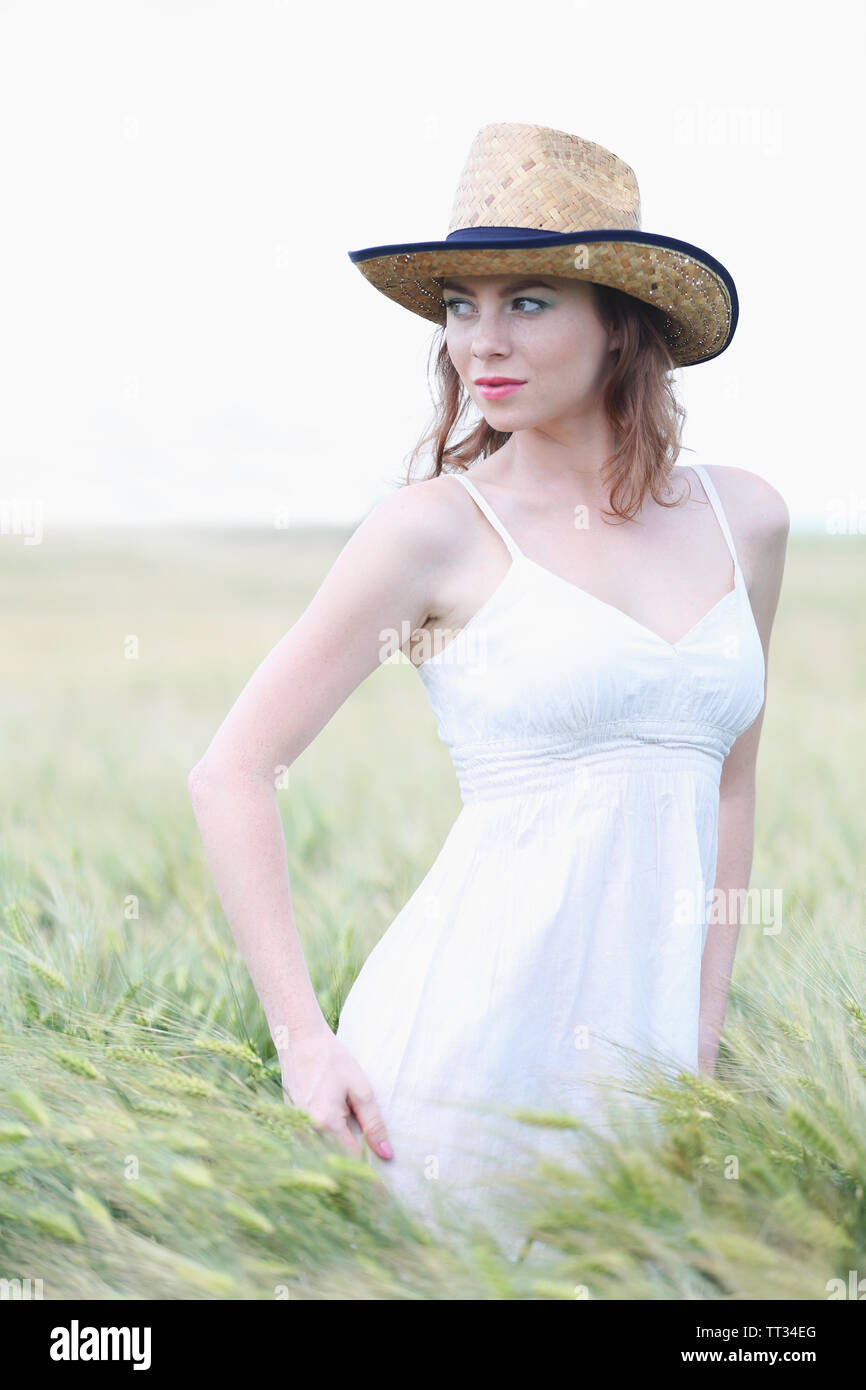 Beautiful young woman in field Stock Photo - Alamy