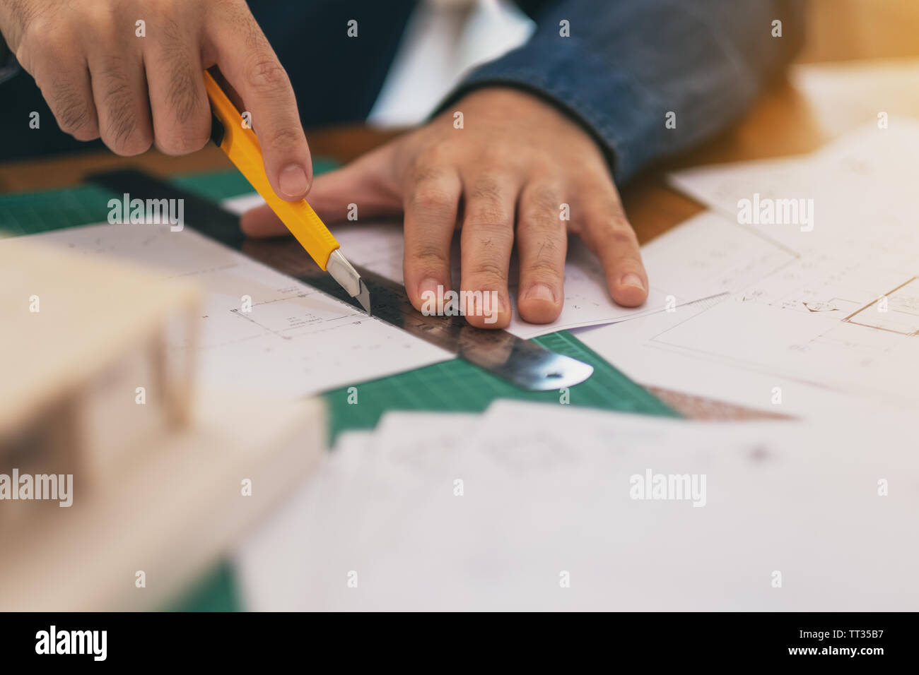 An architect working and cutting papers in office Stock Photo - Alamy