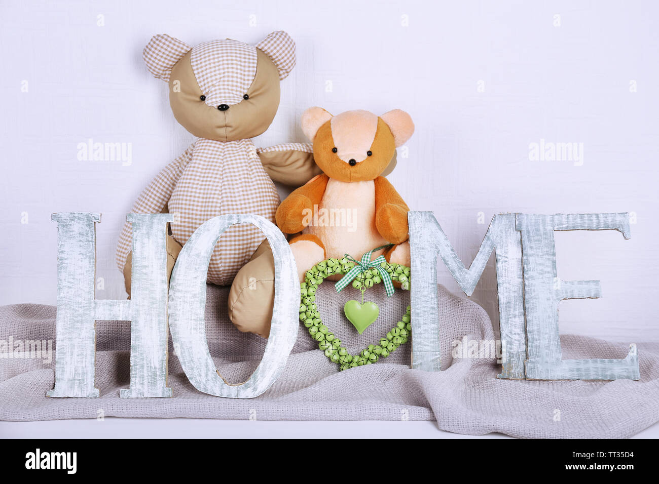 Decorative letters forming word HOME with teddy bear on wall background ...