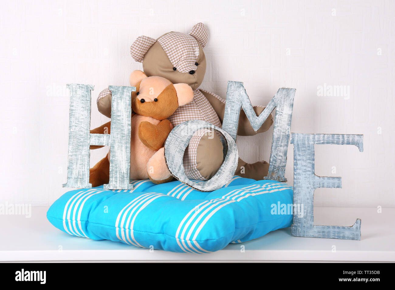 Decorative letters forming word HOME with teddy bear on wall background ...