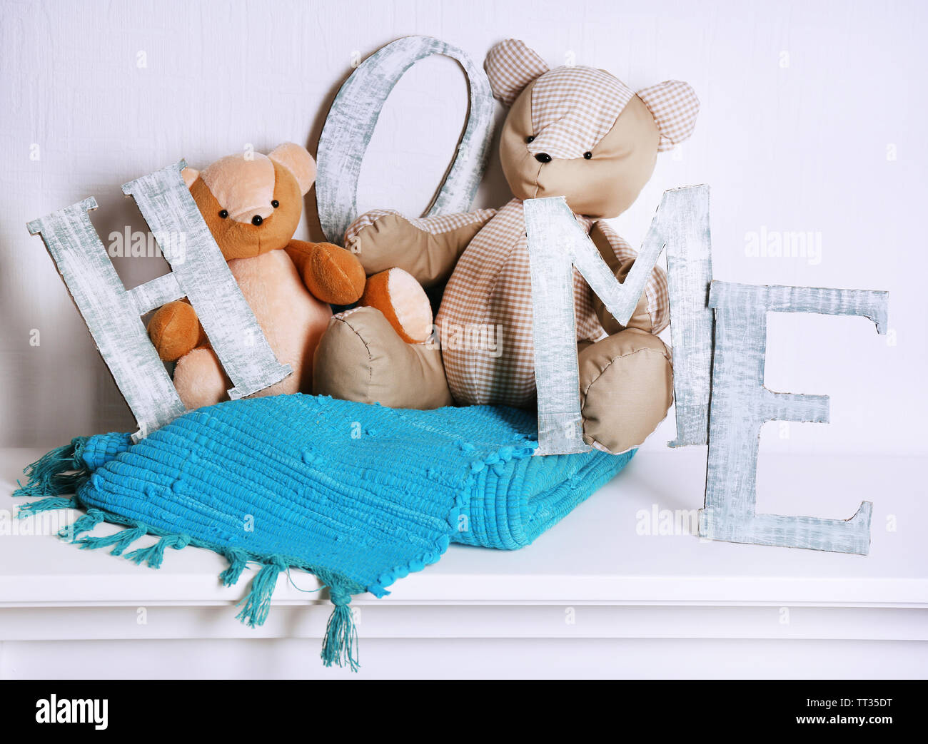 Decorative letters forming word HOME with teddy bear on wall background ...