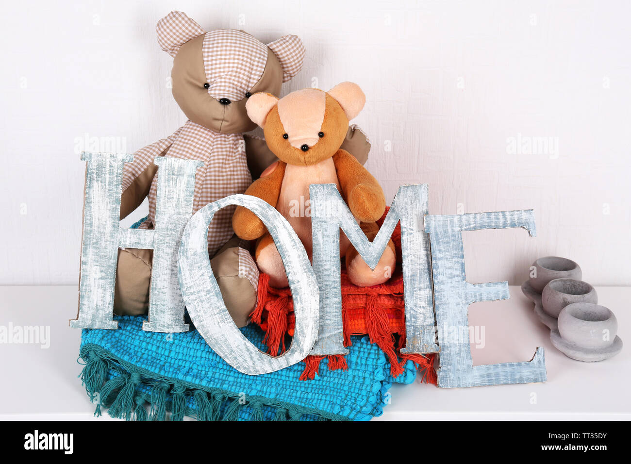 Decorative letters forming word HOME with teddy bear on wall background ...