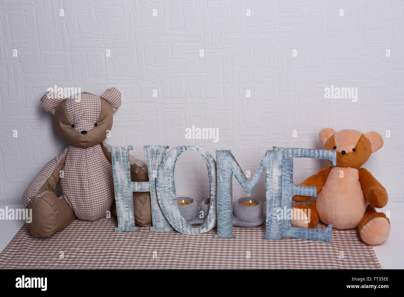 Decorative letters forming word HOME with teddy bear on wall background ...