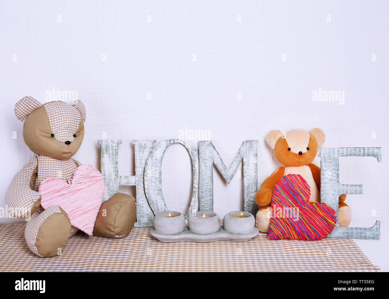 Decorative letters forming word HOME with teddy bear on wall background ...