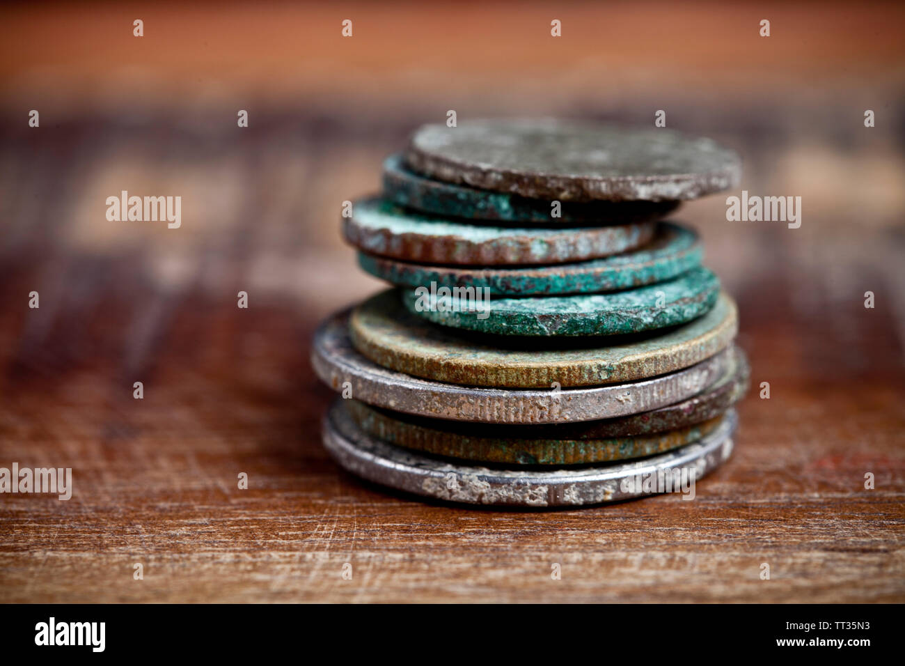 Stack of different ancient copper coins with patina on rustic wooden ...
