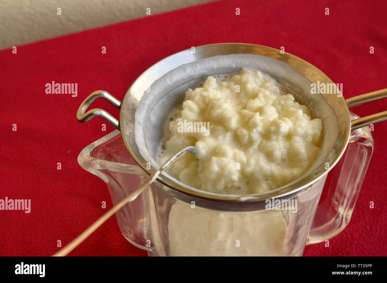 Pouring of the Kefir, the hand of a Caucasian man gently moves the ...