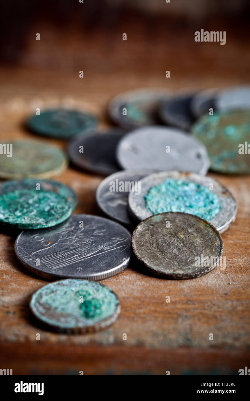 Pile of different ancient copper coins closeup on rustic wooden table ...