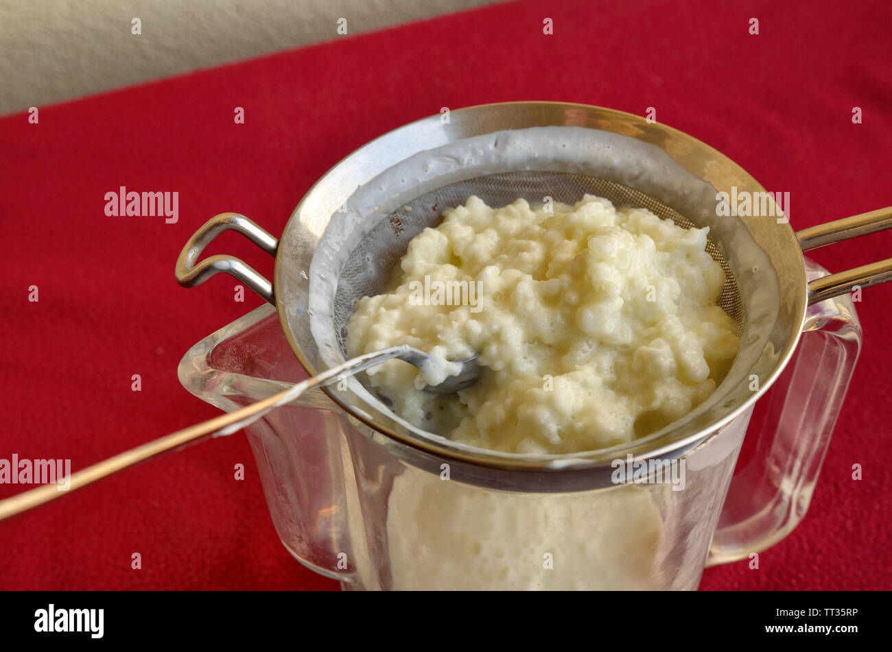 Pouring of the Kefir, the hand of a Caucasian man gently moves the ...