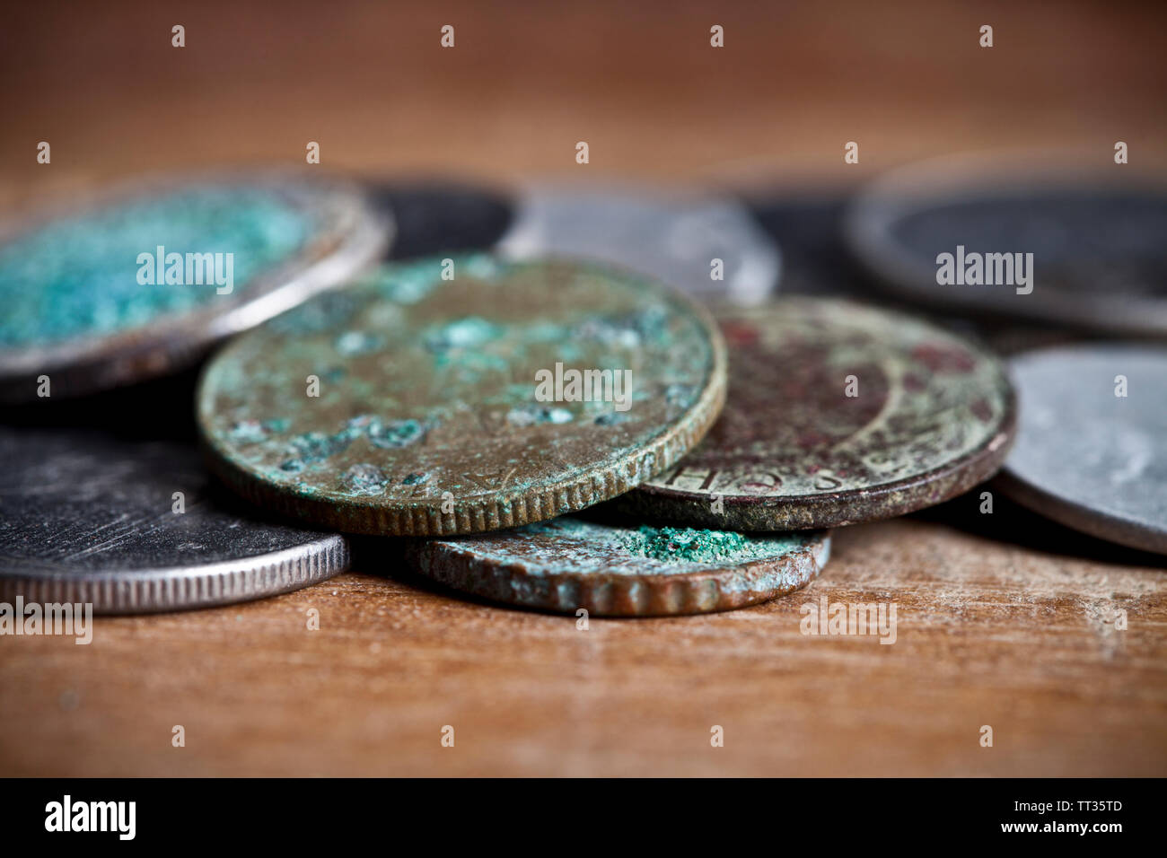 Pile of different ancient copper coins with patina ccloseup on rustic ...
