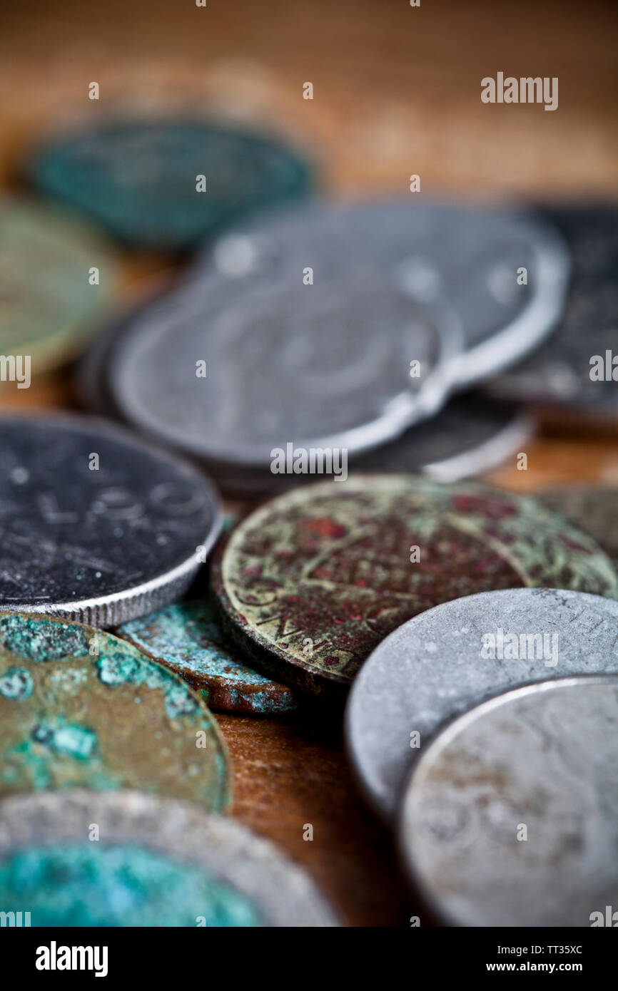 Tarnished and partially corroded old copper coins closeup on rustic ...