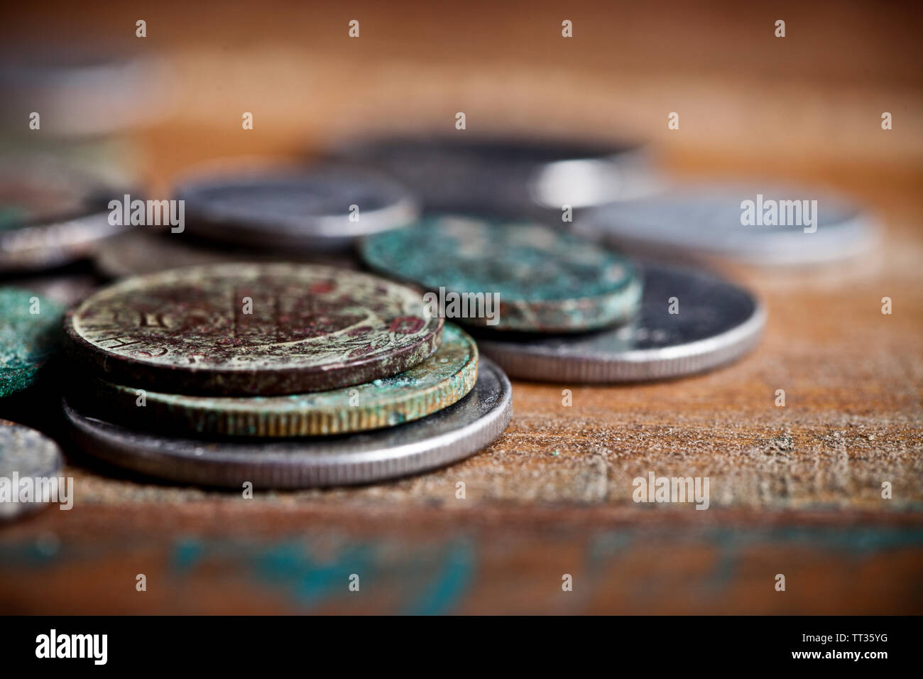 Pile of different ancient copper coins with patina closeup on rustic ...