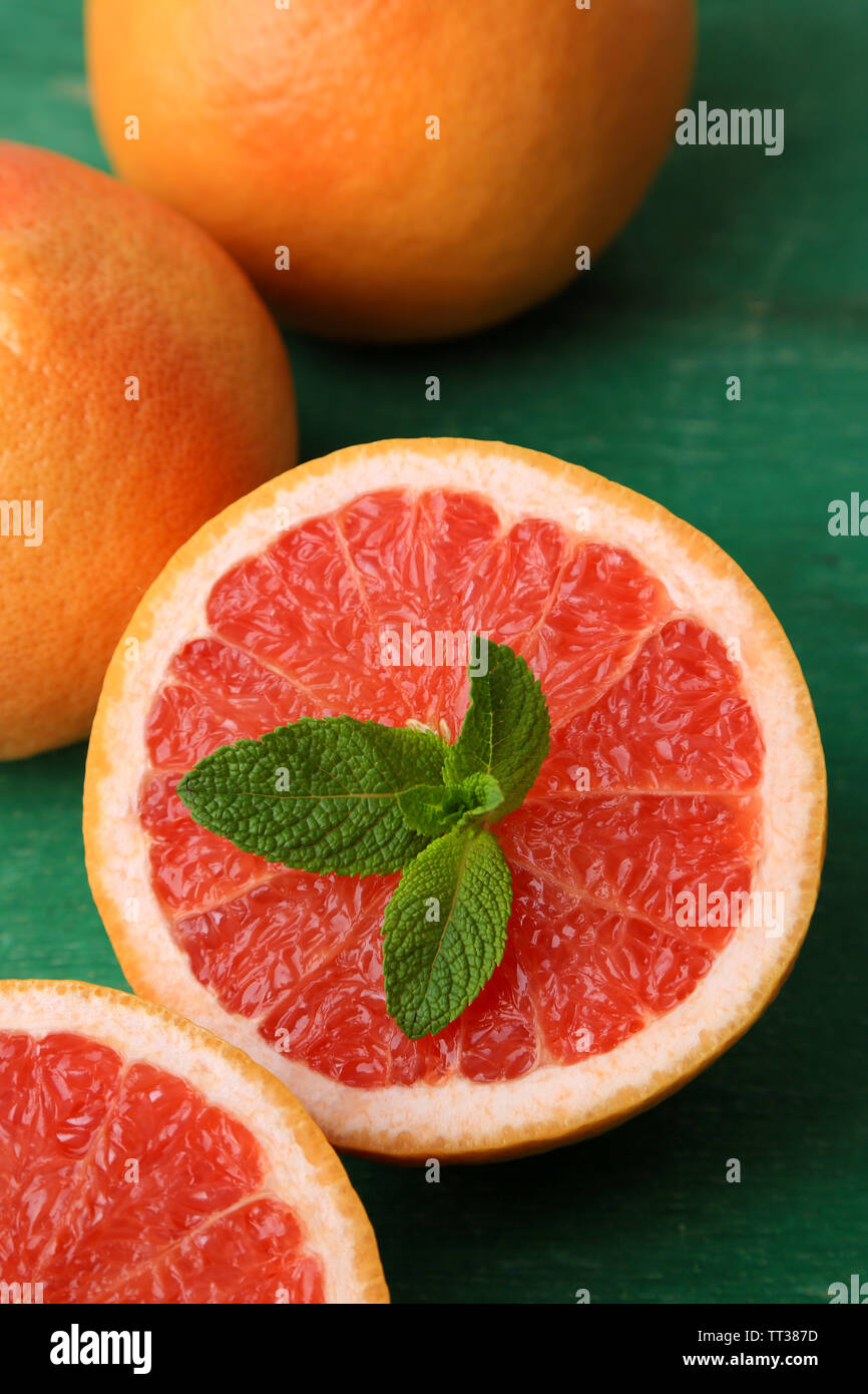 Ripe grapefruits on color wooden background Stock Photo - Alamy