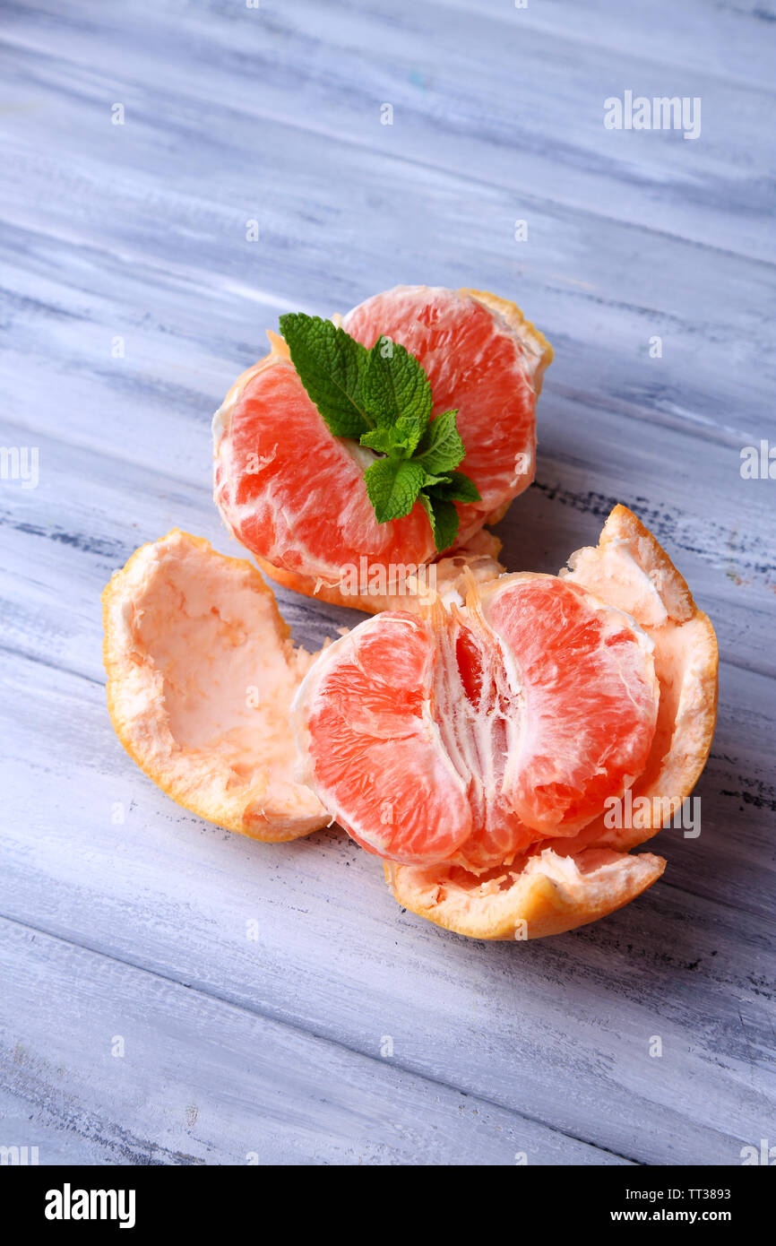 Ripe peeled grapefruits on color wooden background Stock Photo - Alamy