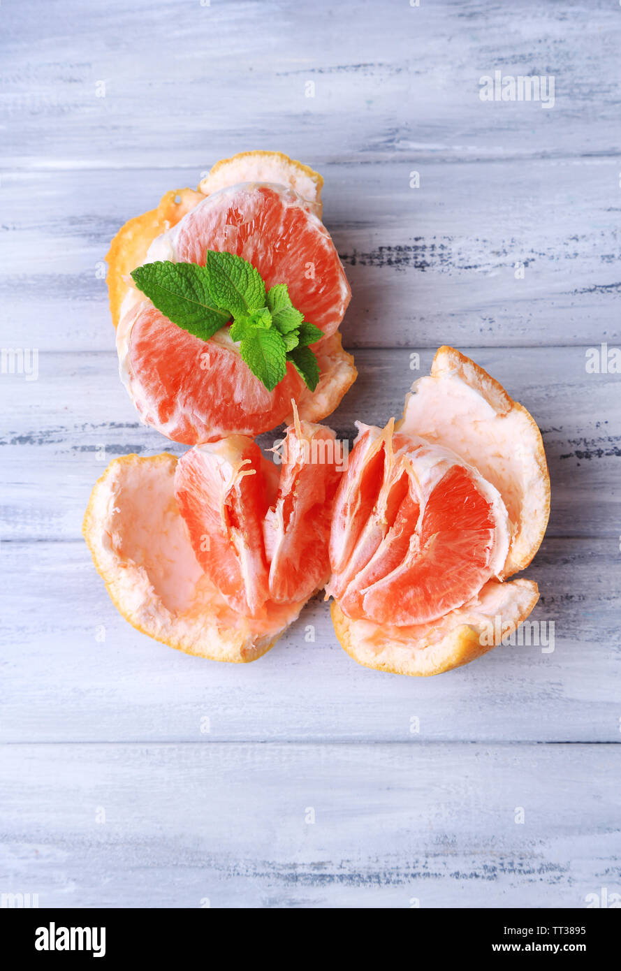 Ripe peeled grapefruits on color wooden background Stock Photo - Alamy