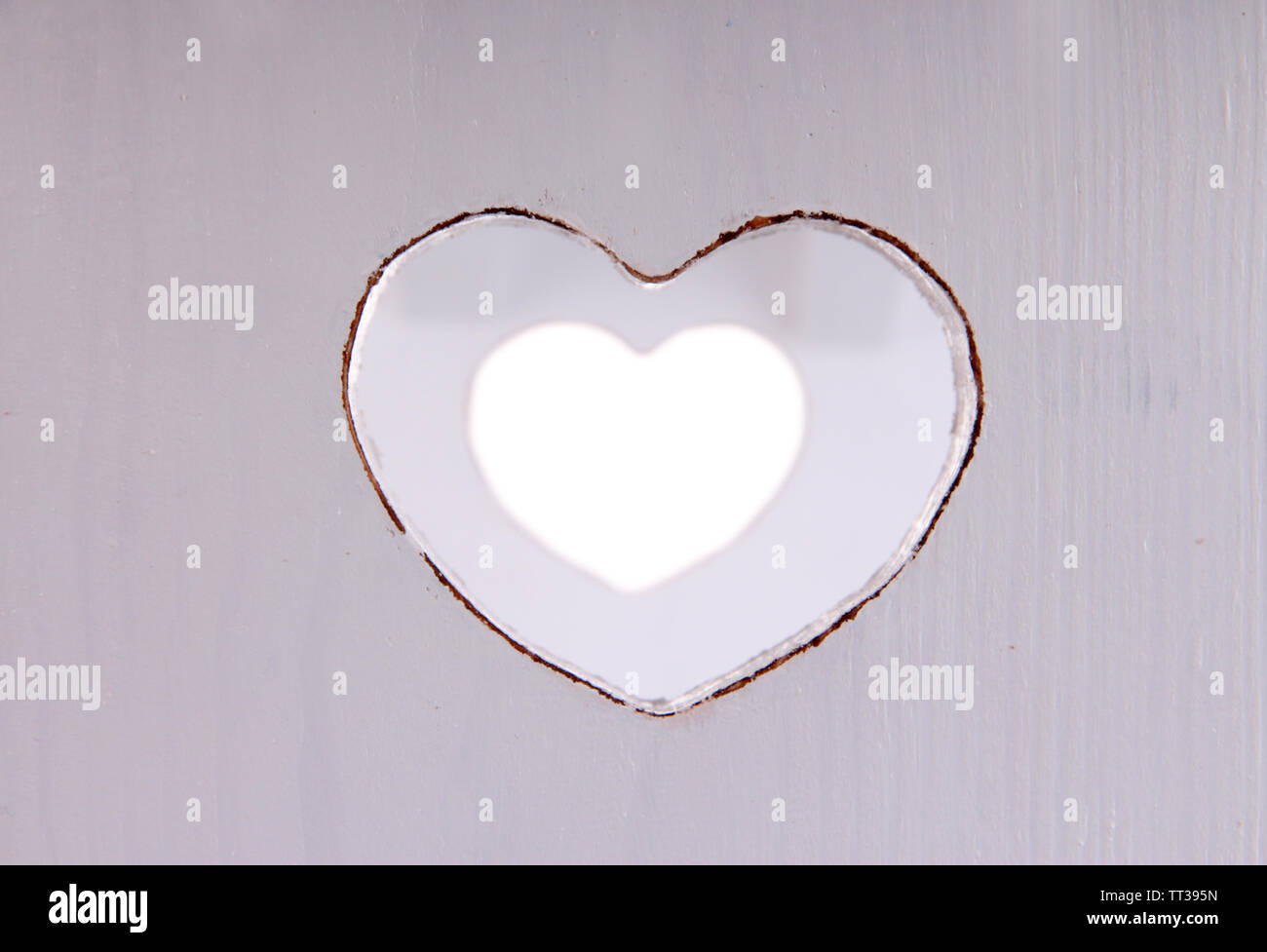 Wooden board with heart shaped window Stock Photo - Alamy