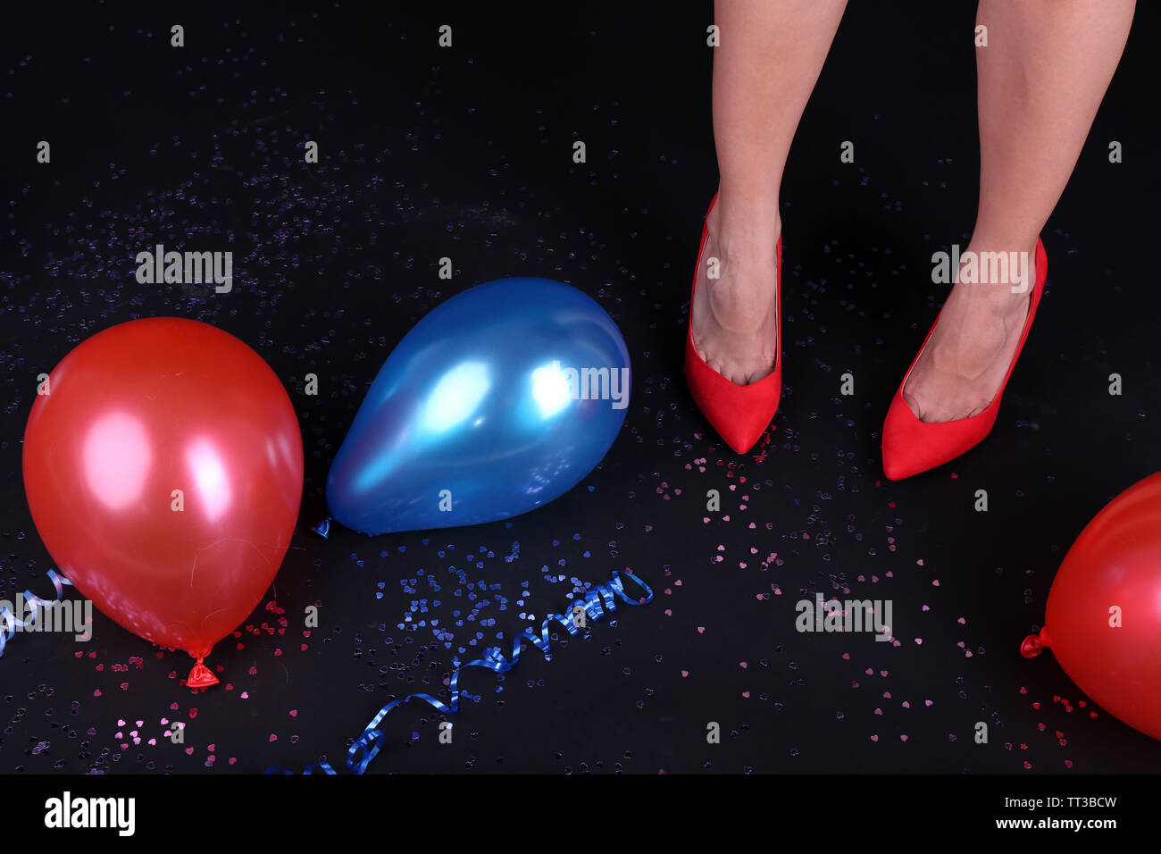 Legs with confetti and balloons on the floor Stock Photo - Alamy