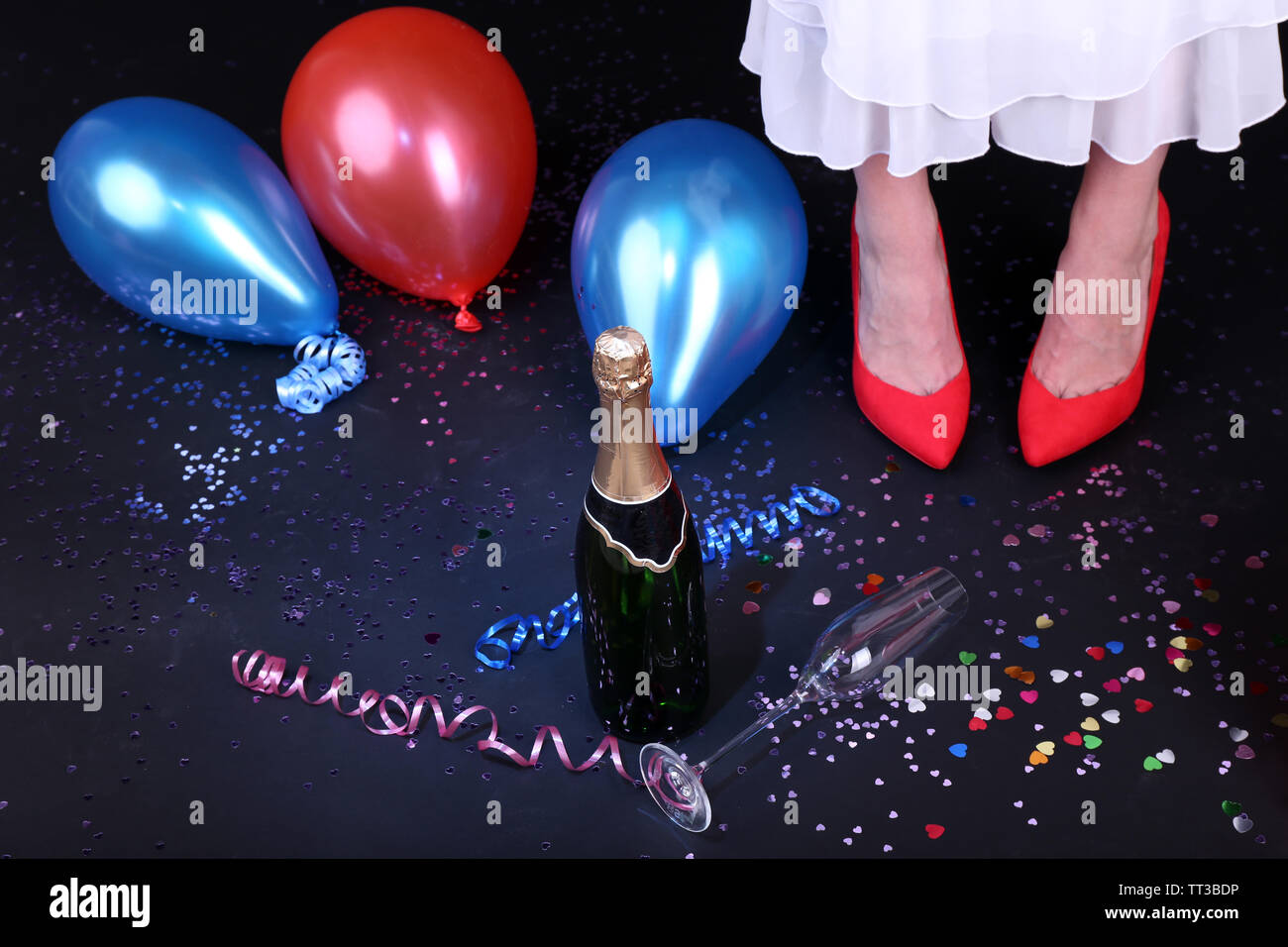 Legs with confetti, champagne and balloons on the floor Stock Photo - Alamy