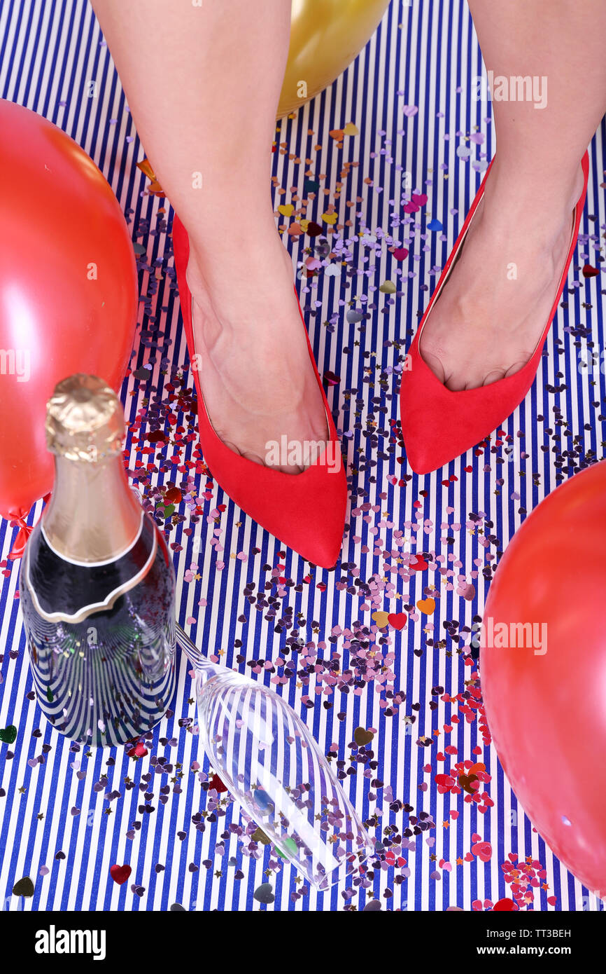 Legs with confetti, champagne and balloons on the floor Stock Photo - Alamy