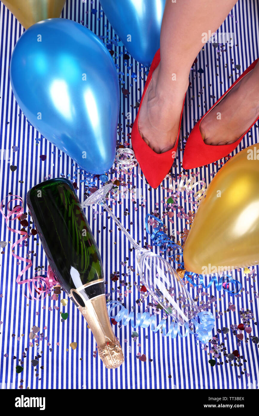 Legs with confetti, champagne and balloons on the floor Stock Photo - Alamy