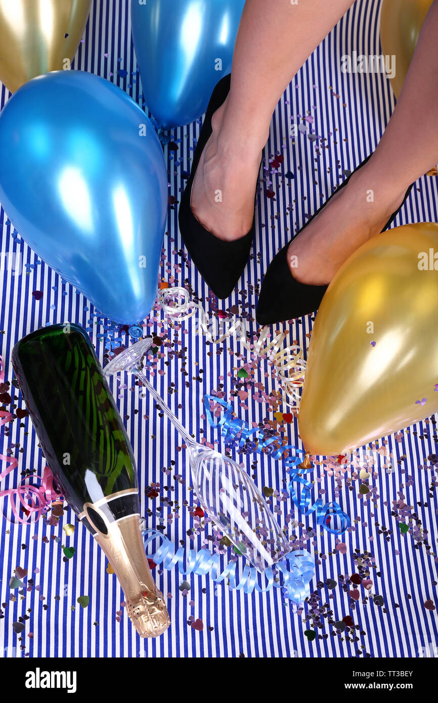Legs with confetti, champagne and balloons on the floor Stock Photo - Alamy