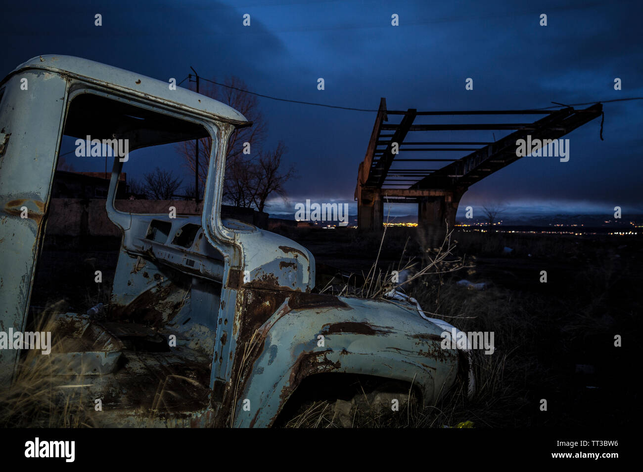 Old truck cabin in front of an abandoned soviet era bus stop. Armenia ...