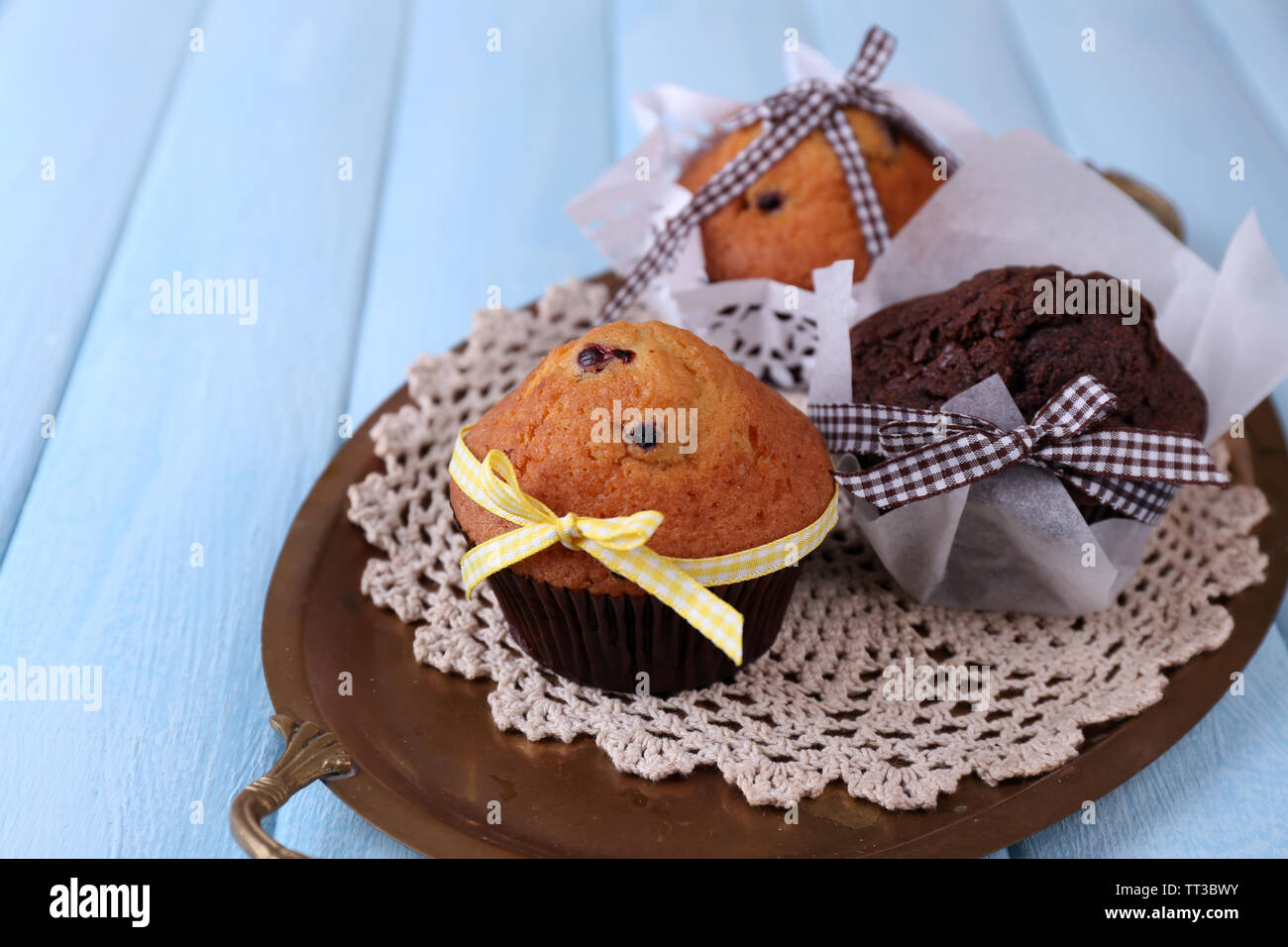 Tasty muffins on tray, on color wooden background Stock Photo - Alamy