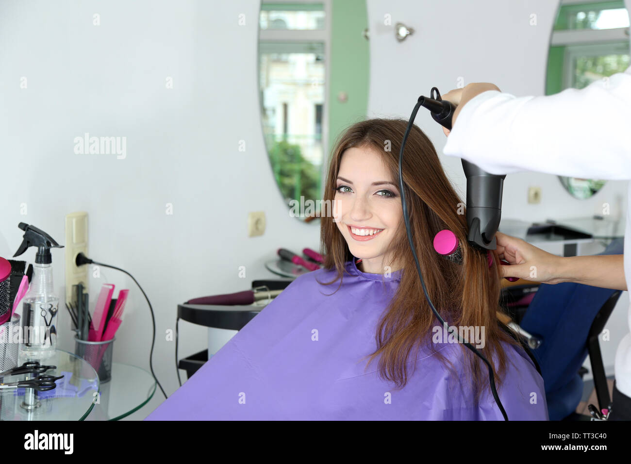 Young woman hairdresser do hairstyle girl in beauty salon Stock Photo ...