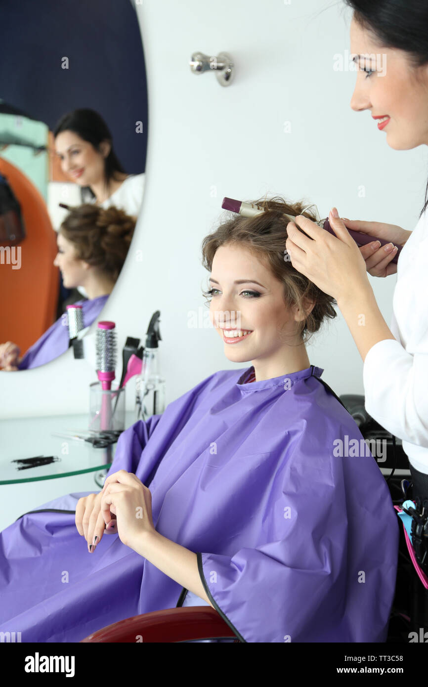 Young woman hairdresser do hairstyle girl in beauty salon Stock Photo ...