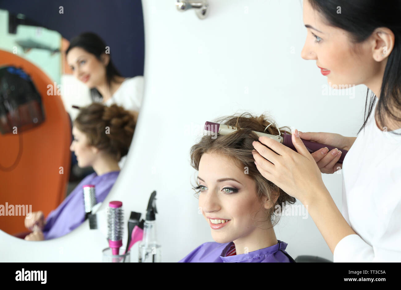 Young woman hairdresser do hairstyle girl in beauty salon Stock Photo ...