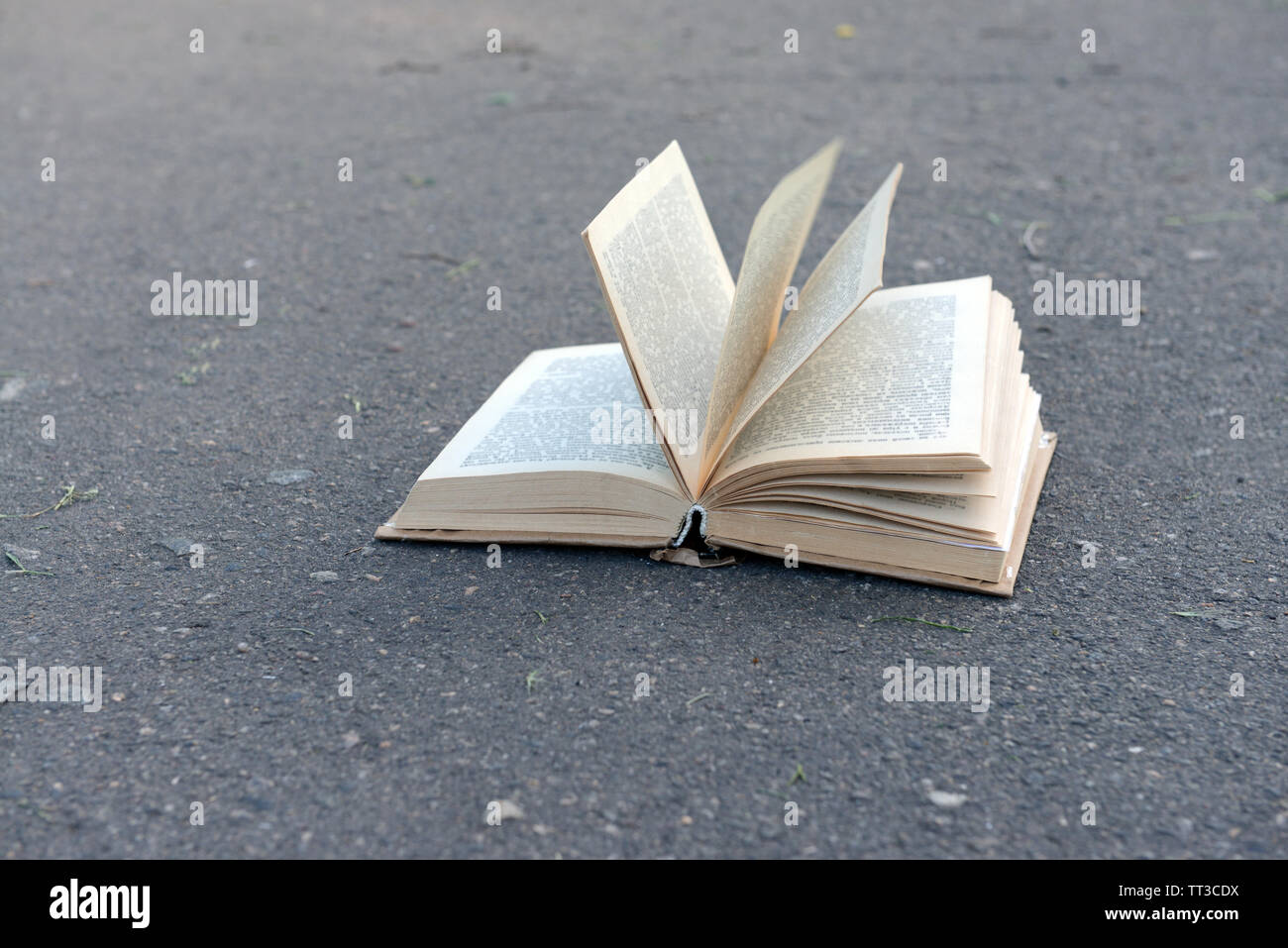 Open book on road outdoors Stock Photo - Alamy
