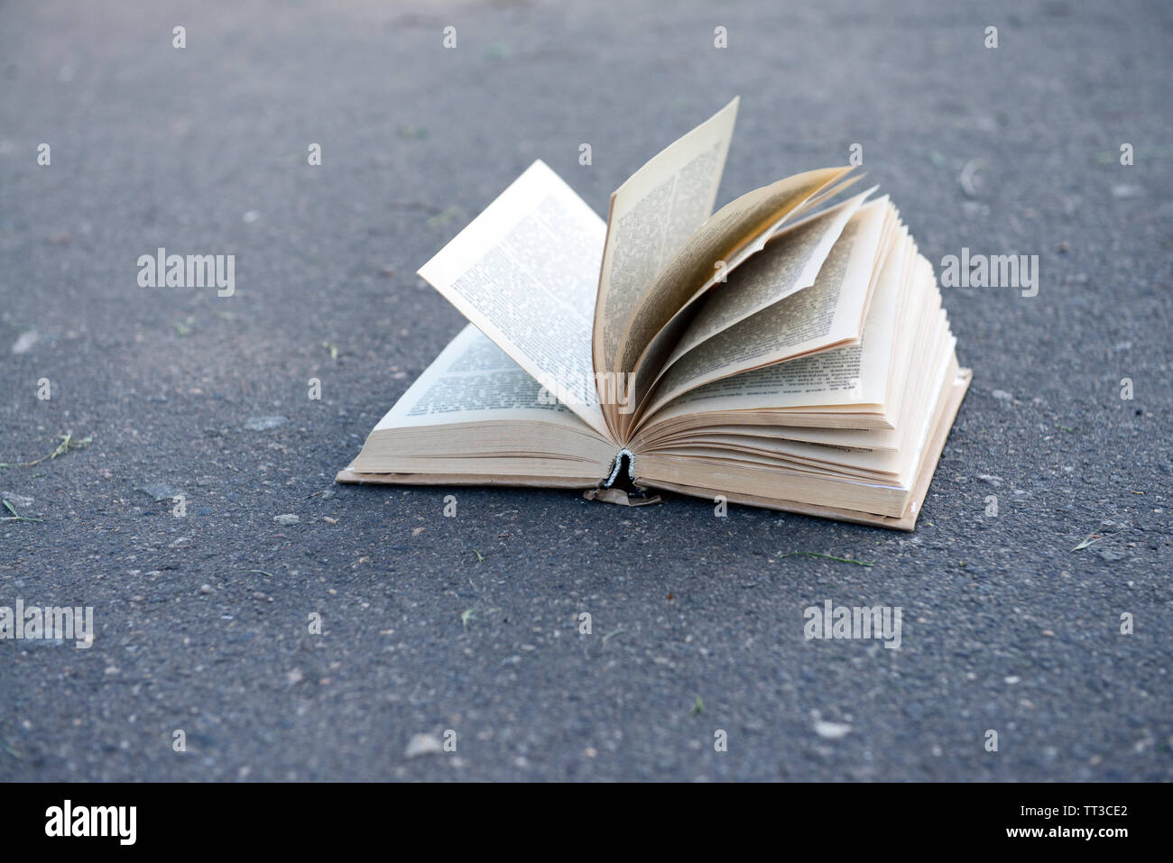 Open book on road outdoors Stock Photo - Alamy