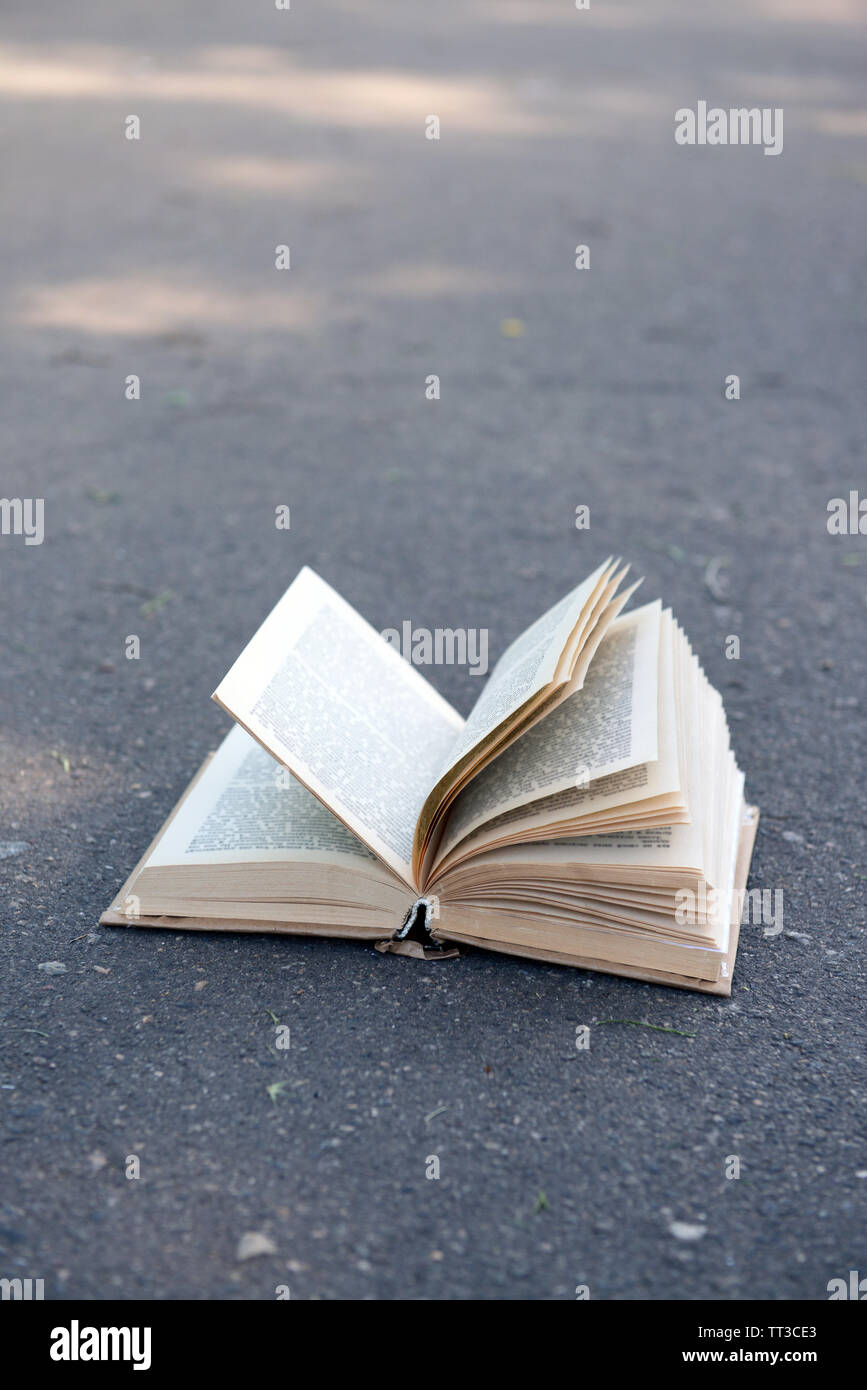 Open book on road outdoors Stock Photo - Alamy