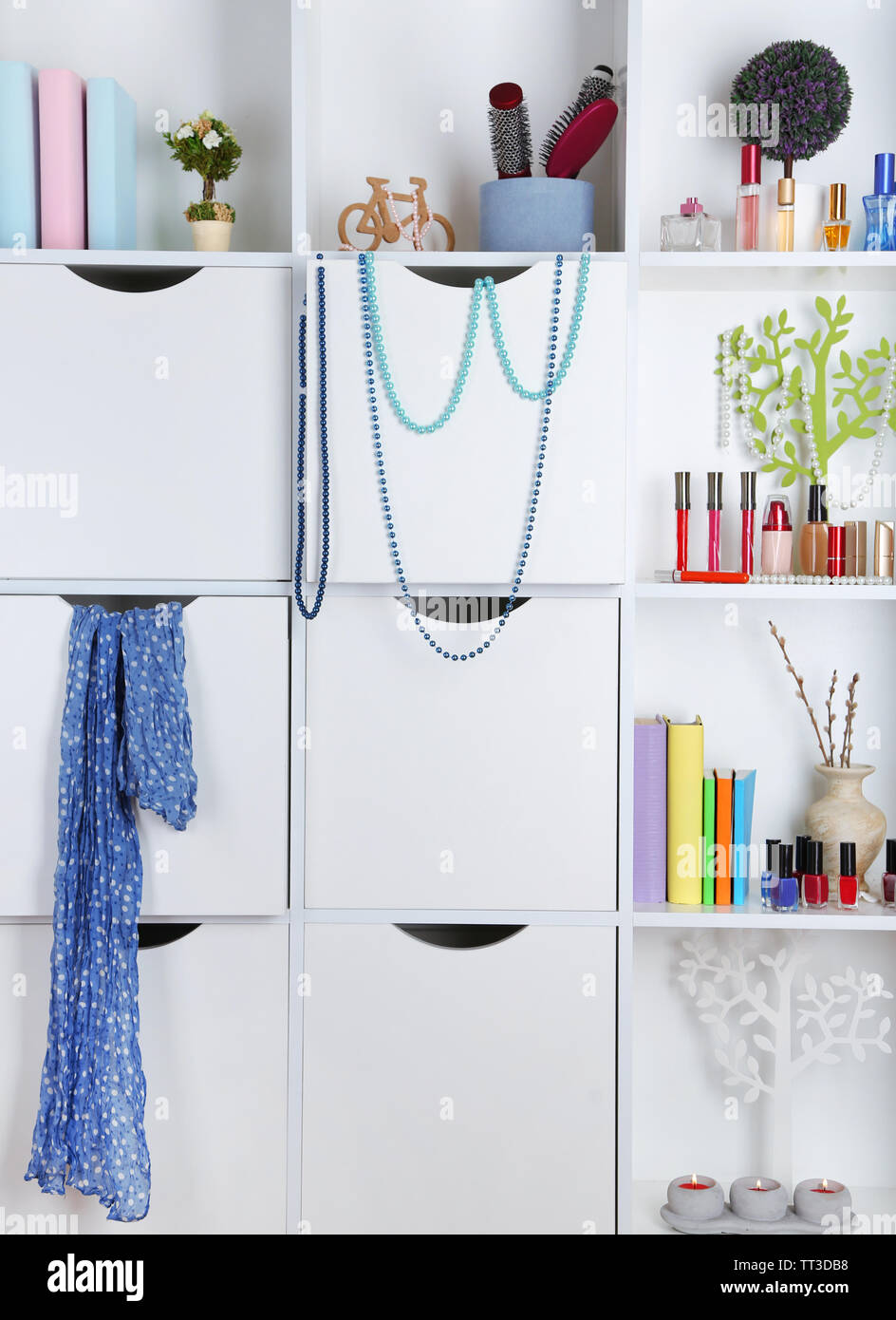 Beautiful white drawers and shelves with different home related objects ...