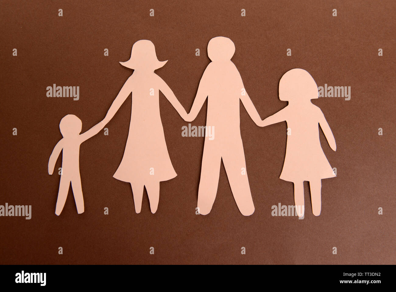 Paper family on brown background Stock Photo - Alamy
