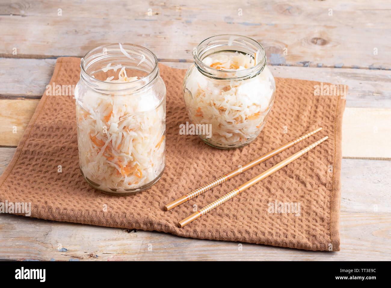 fermented cabbage in jar, wooden background and copy space, canned meal ...