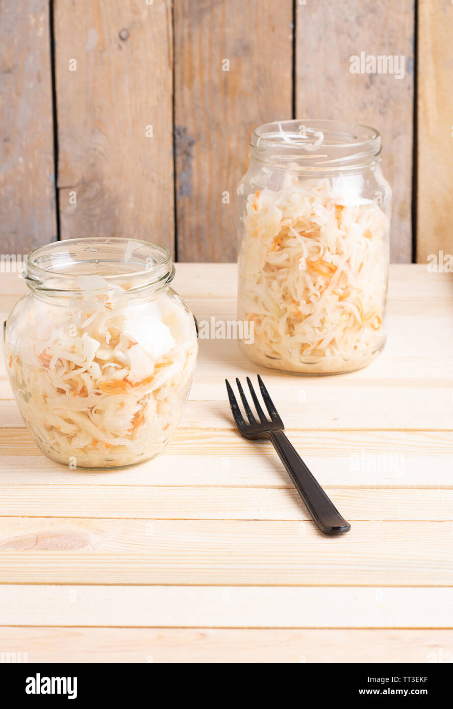 fermented cabbage in jar, wooden background and copy space, canned meal ...