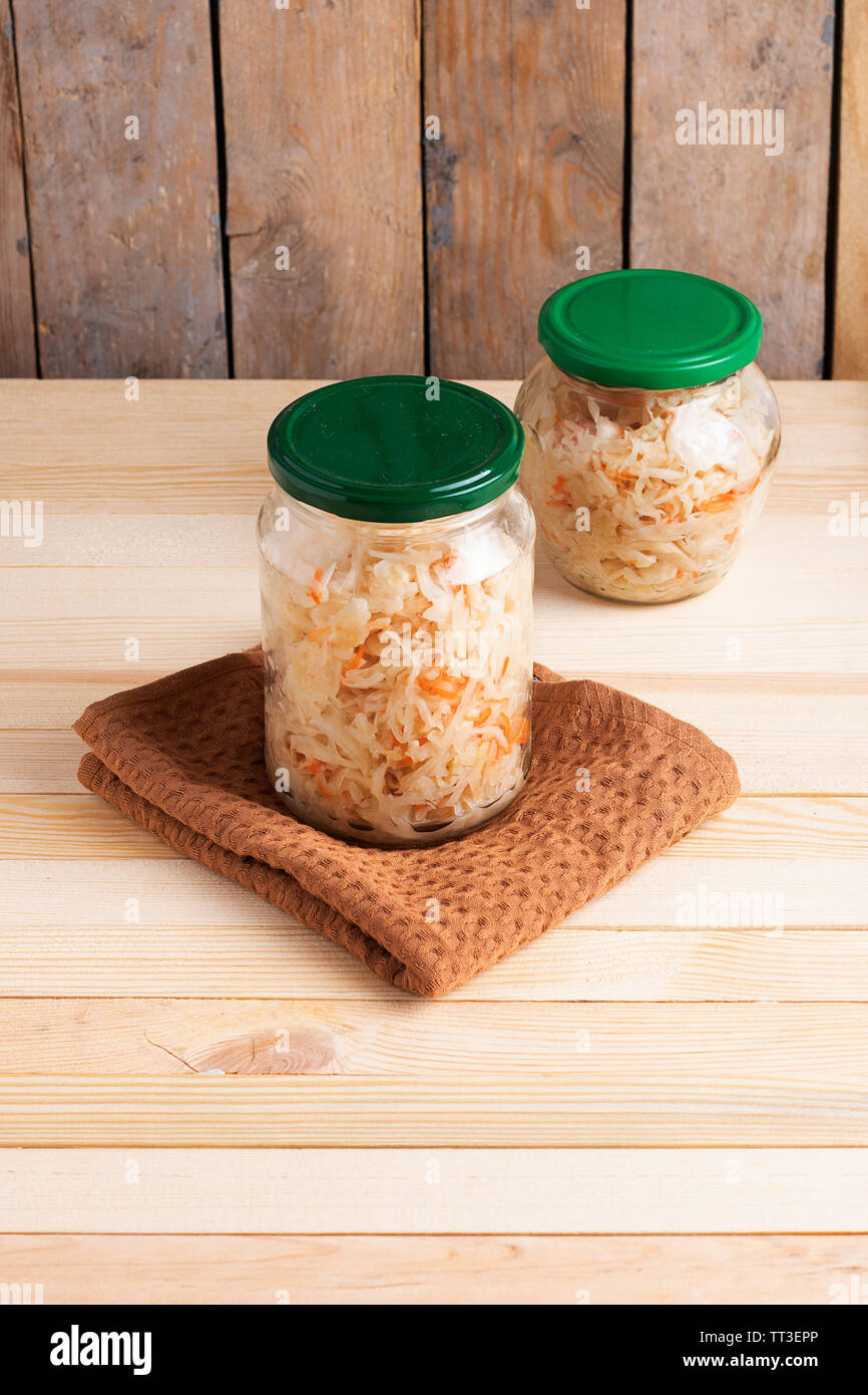 fermented cabbage in jar, wooden background and copy space, canned meal ...