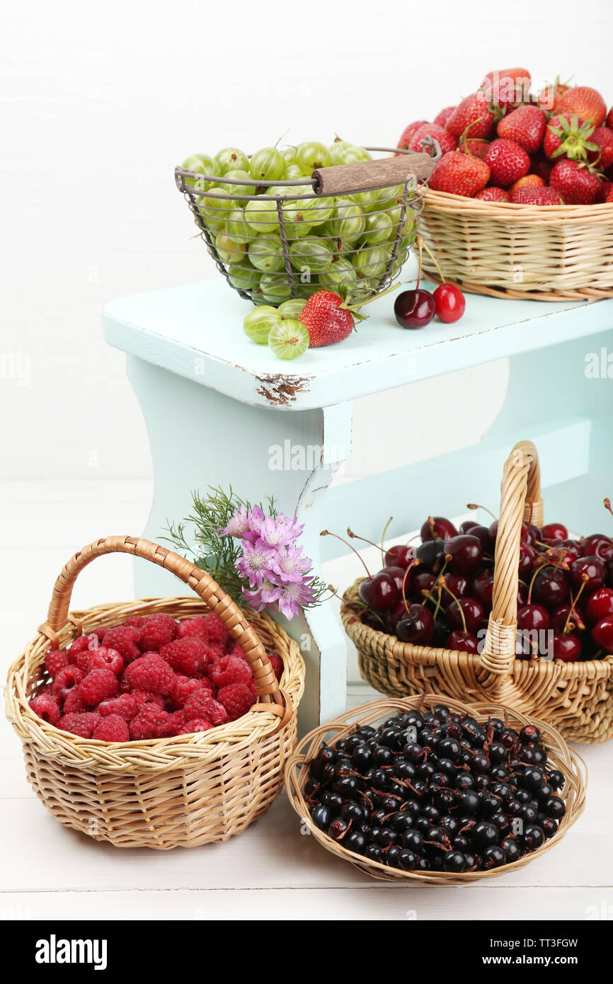 Fresh berries in baskets on white wall background Stock Photo - Alamy