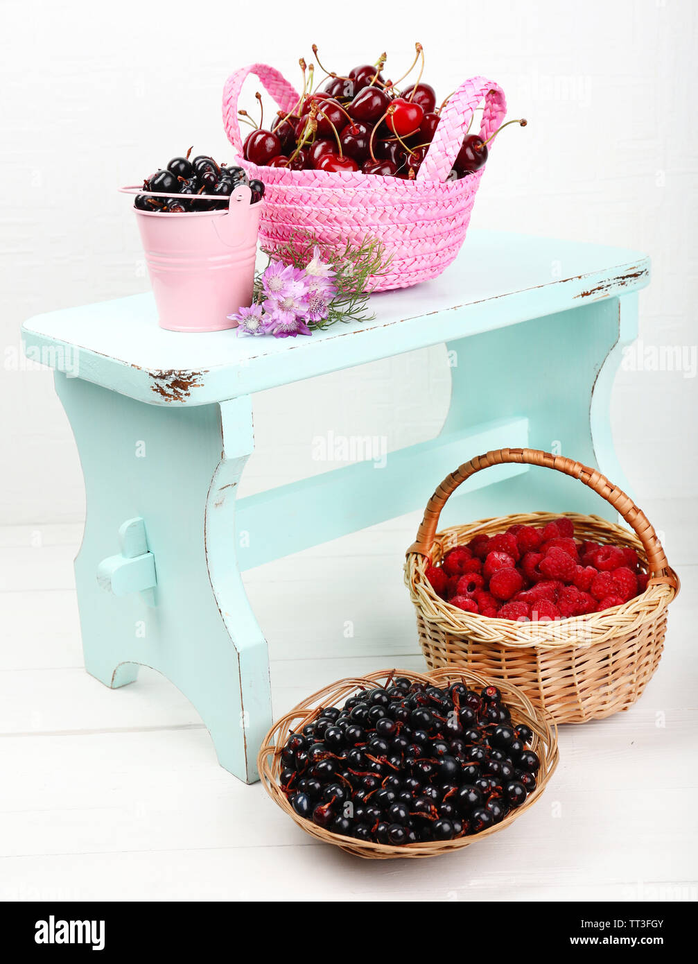 Fresh berries in baskets on white wall background Stock Photo - Alamy