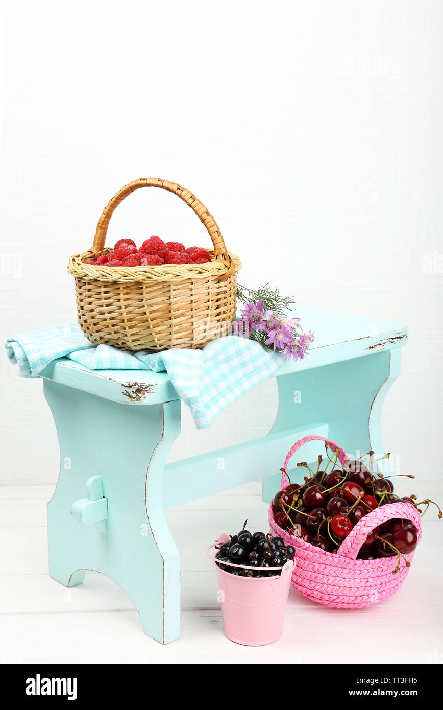 Fresh berries in baskets on white wall background Stock Photo - Alamy