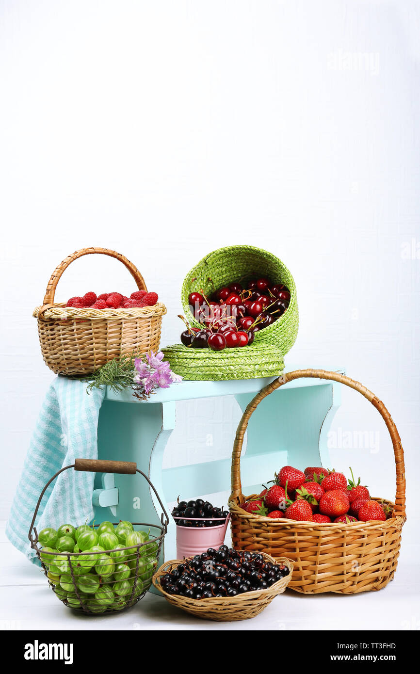 Fresh berries in baskets on white wall background Stock Photo - Alamy
