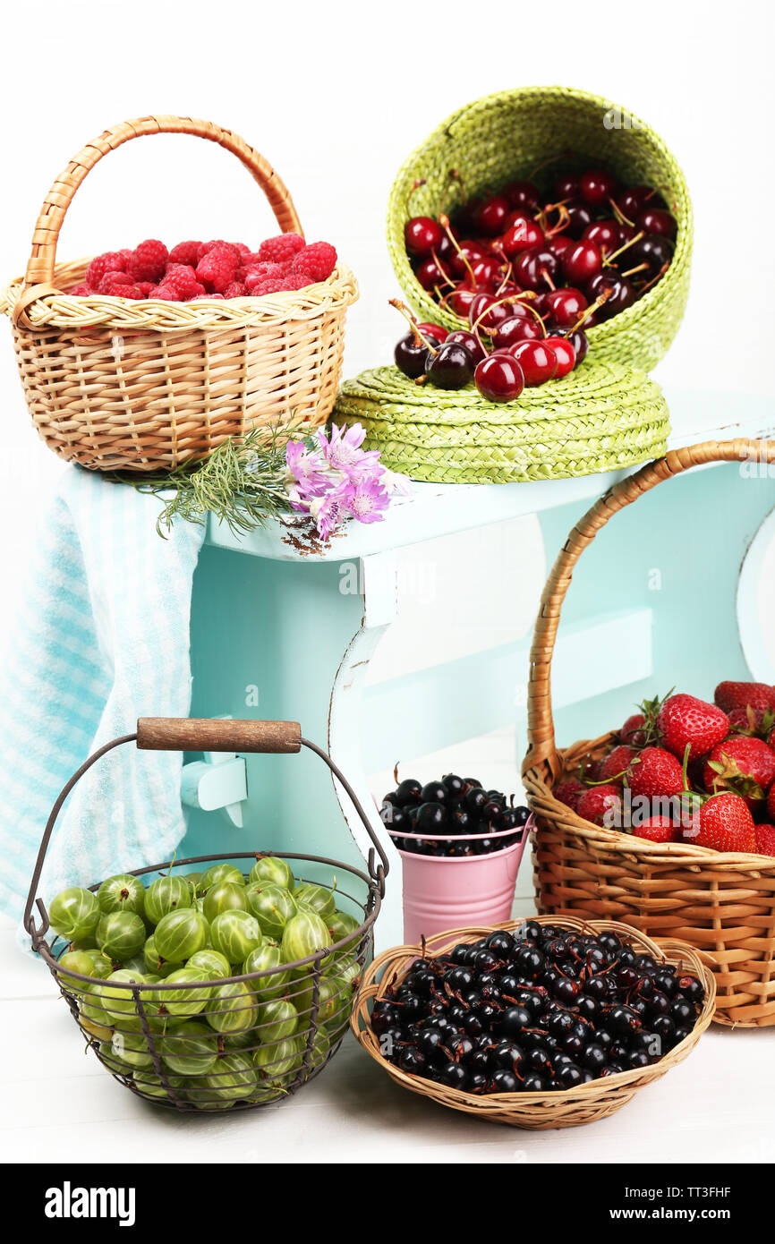 Fresh berries in baskets on white wall background Stock Photo - Alamy