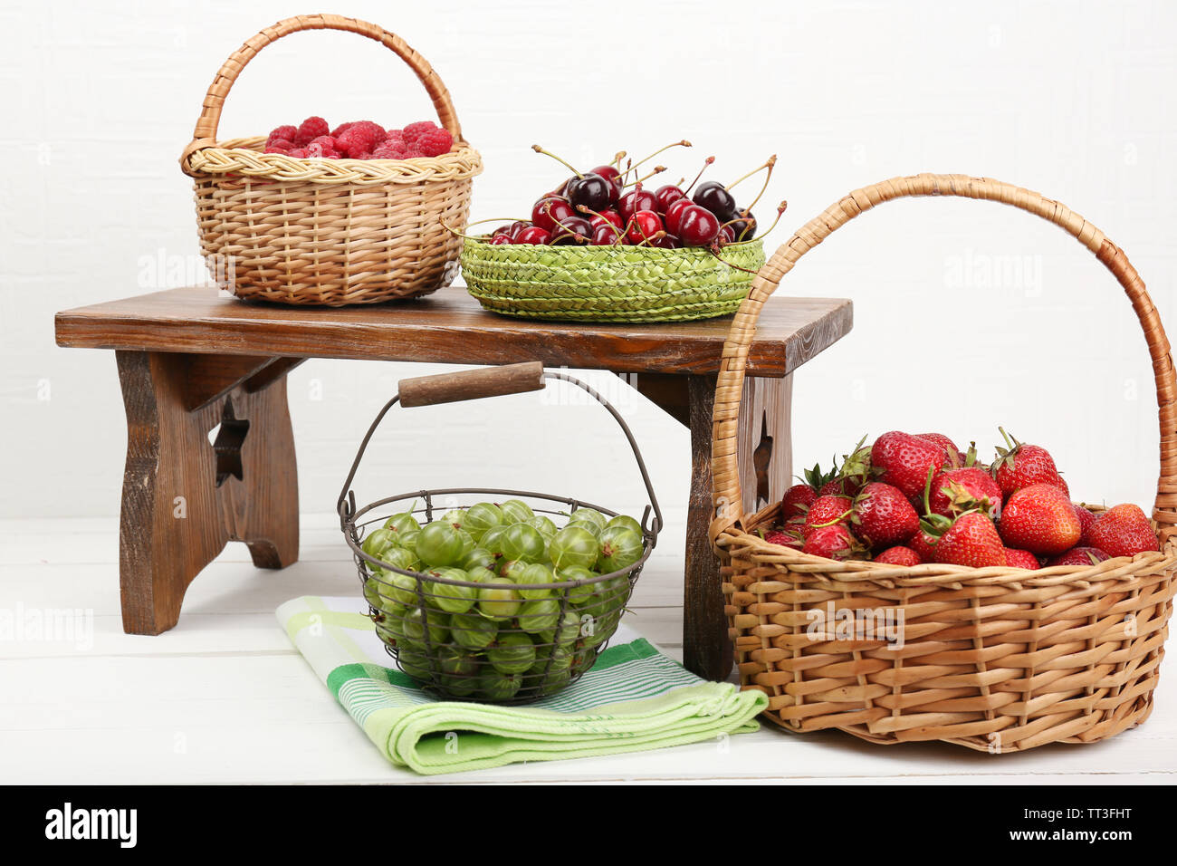 Fresh berries in baskets on white wall background Stock Photo - Alamy