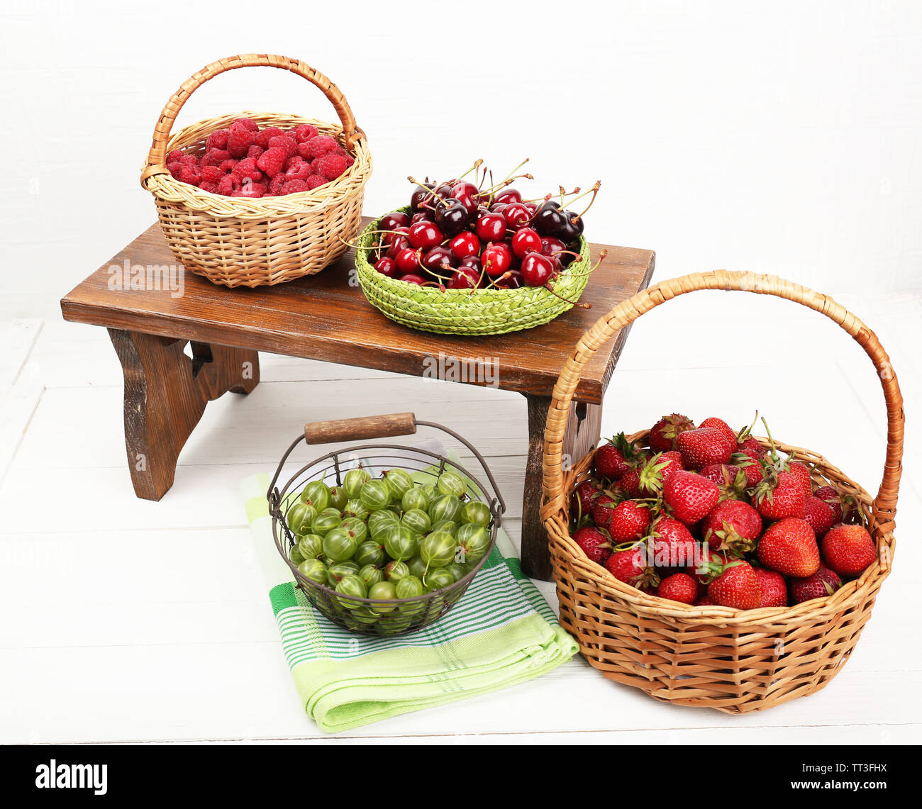 Fresh berries in baskets on white wall background Stock Photo - Alamy
