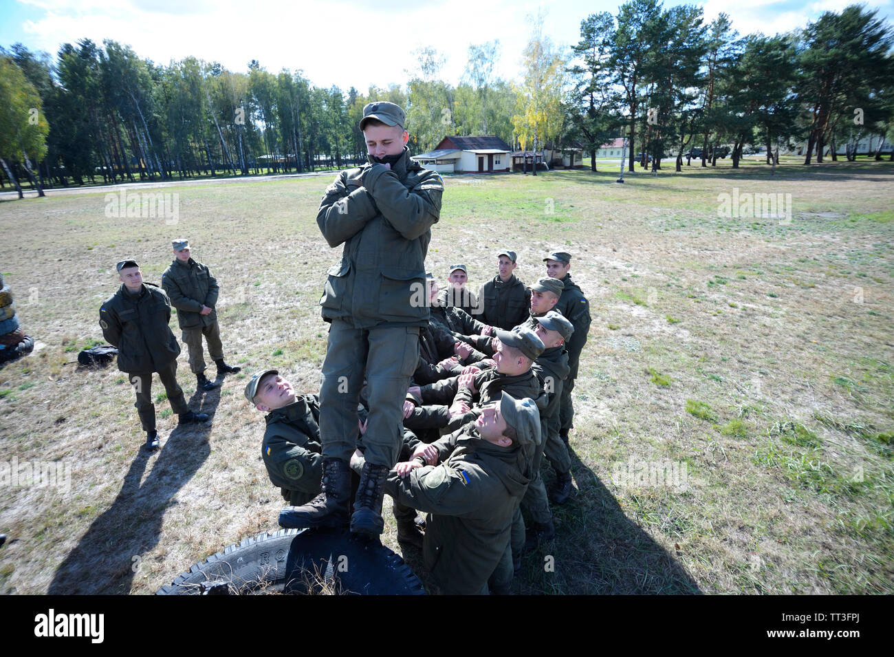 Team-building exercise: soldiers standing and going to catch their ...