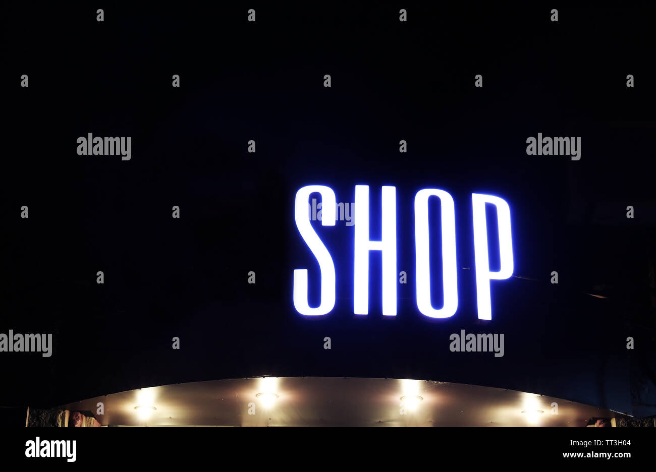 Neon sign on store at night Stock Photo - Alamy