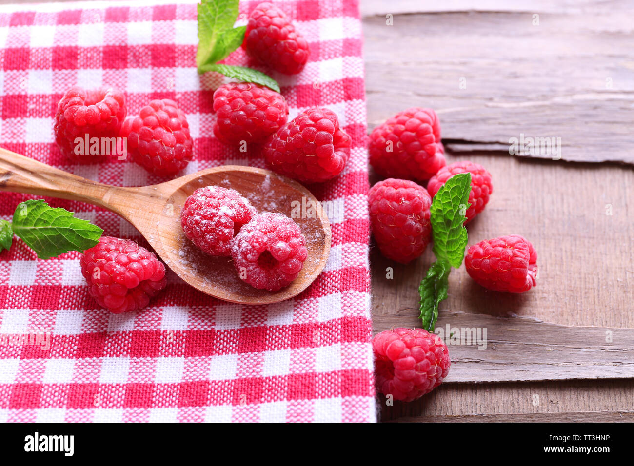 Ripe sweet raspberries in spoon on table close-up Stock Photo - Alamy