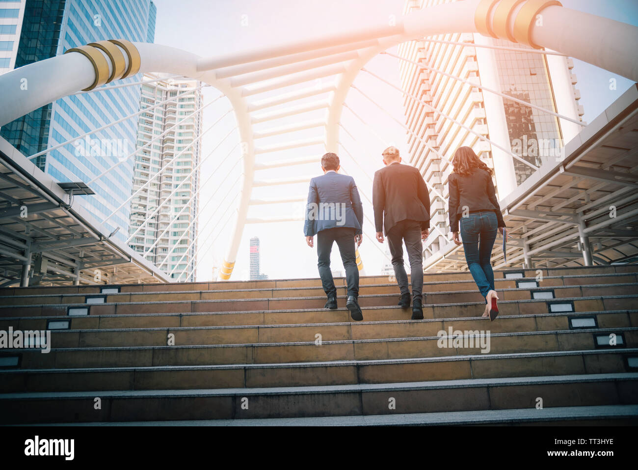 Rear view of business team climbing stairs go to a city. Business ...