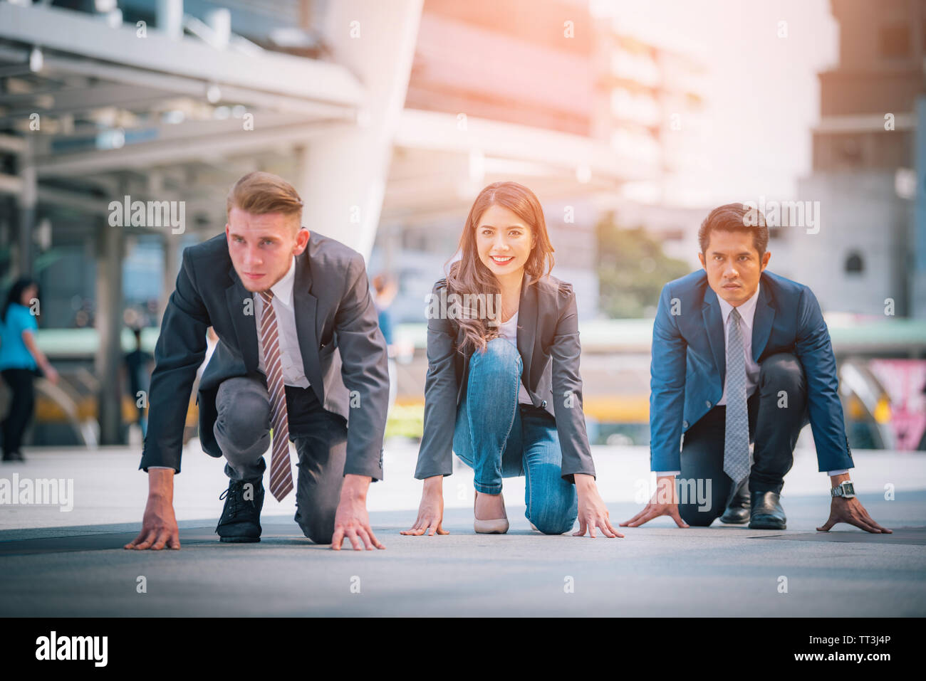 Business team ready to run at start point on blurred city background ...