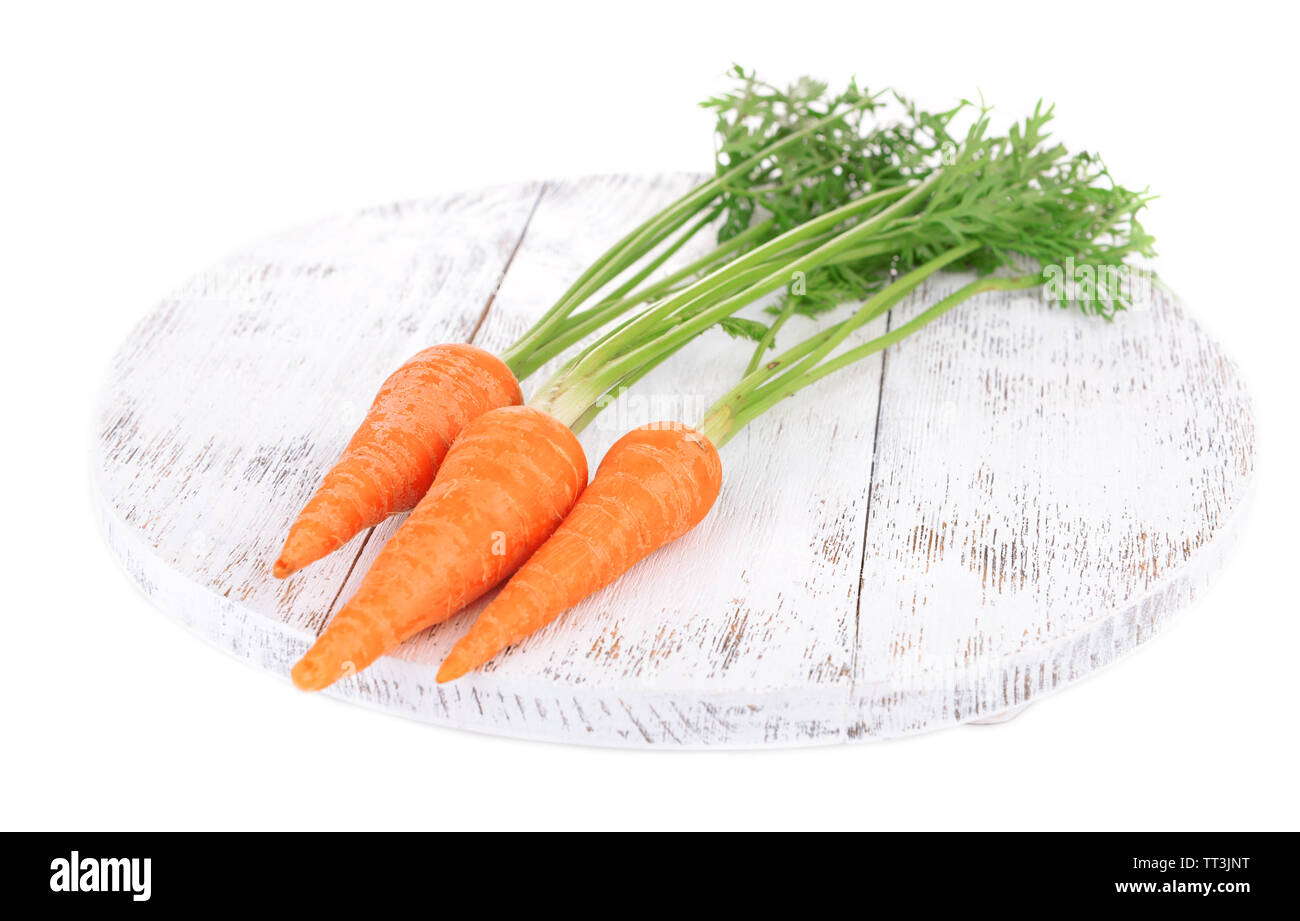 Fresh carrot on wooden stand isolated on white Stock Photo - Alamy